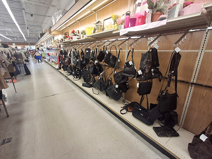 Handbag heaven! This wall of purses, totes, and messenger bags proves one shopper's donation is another's fashion statement waiting to happen.