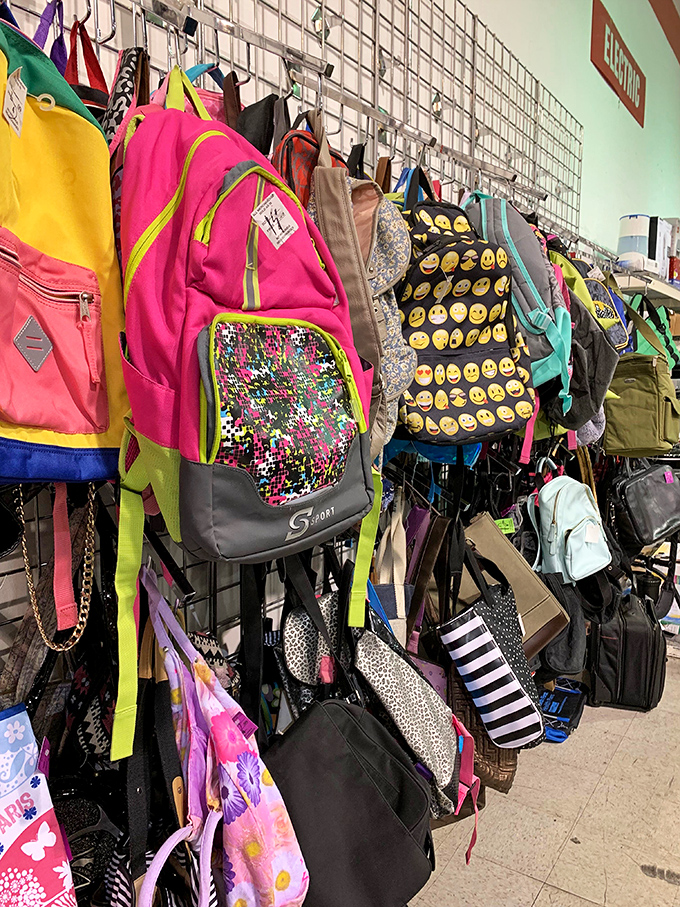 Backpack bonanza! From emoji-covered school gear to practical totes, the accessories wall is a vertical treasure chest of carried possibilities.