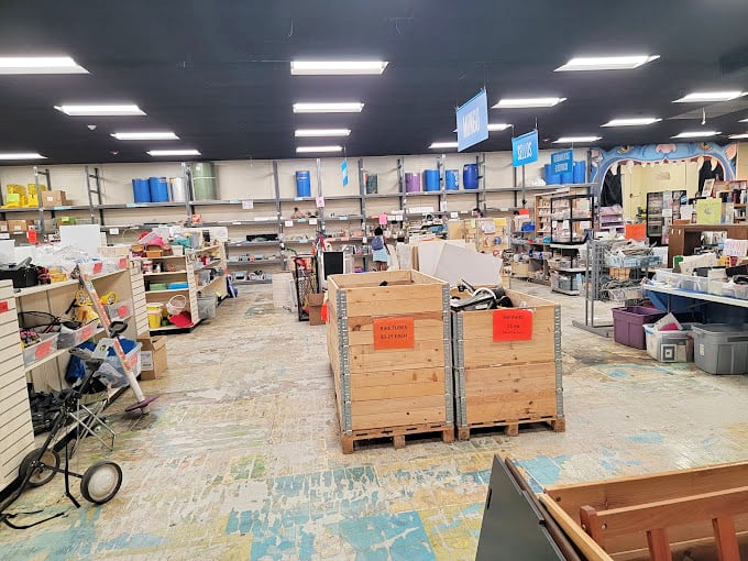 Industrial-sized imagination in wooden crates. Each bin a different category of "someone else's trash" waiting to become your treasure.