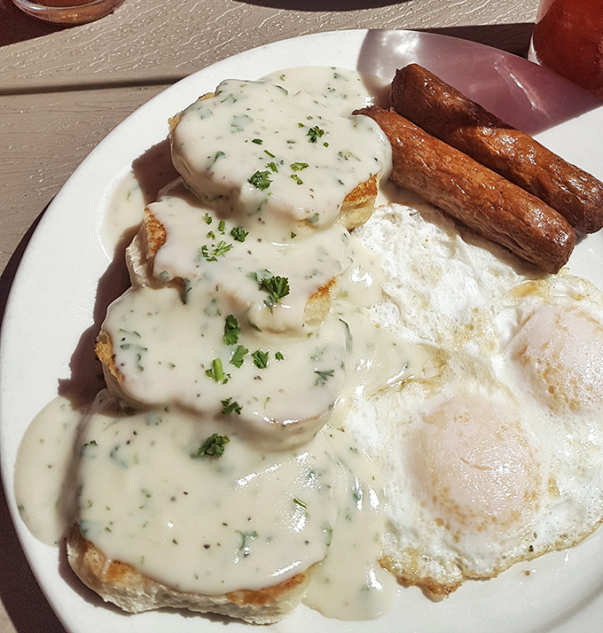 The legendary biscuits and gravy—where flaky, buttery clouds meet a peppery sausage gravy that would make your grandmother both jealous and proud.
