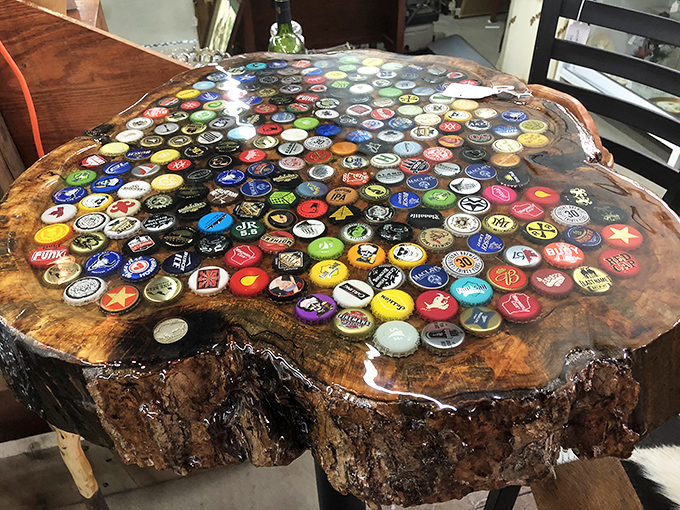 Nature meets bottle caps in this conversation-starting table. Someone's beverage obsession transformed into functional art that tells stories with every cap.