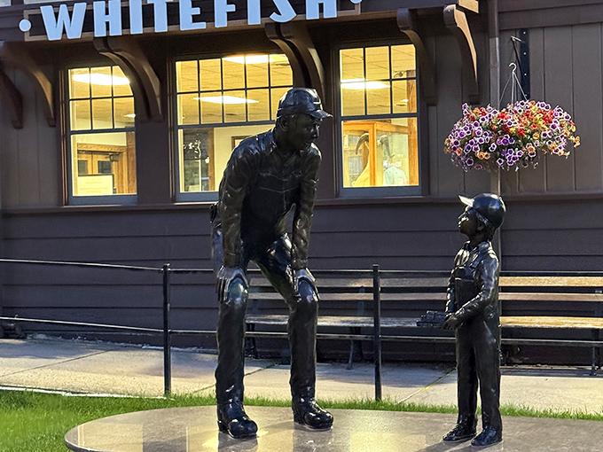 Bronze sculptures outside the train station capture that timeless moment when a parent's fishing wisdom is either being absorbed or politely ignored.