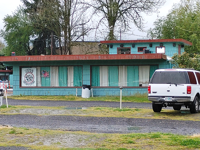 The aqua-blue concession building looks like it was plucked straight from a 1950s postcard, complete with vintage striped awning.