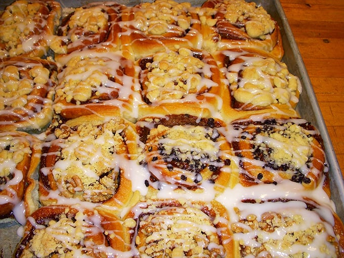 The cinnamon rolls sprawl across their baking sheet like sunbathers on a beach, glistening with sweet glaze and begging to be devoured.
