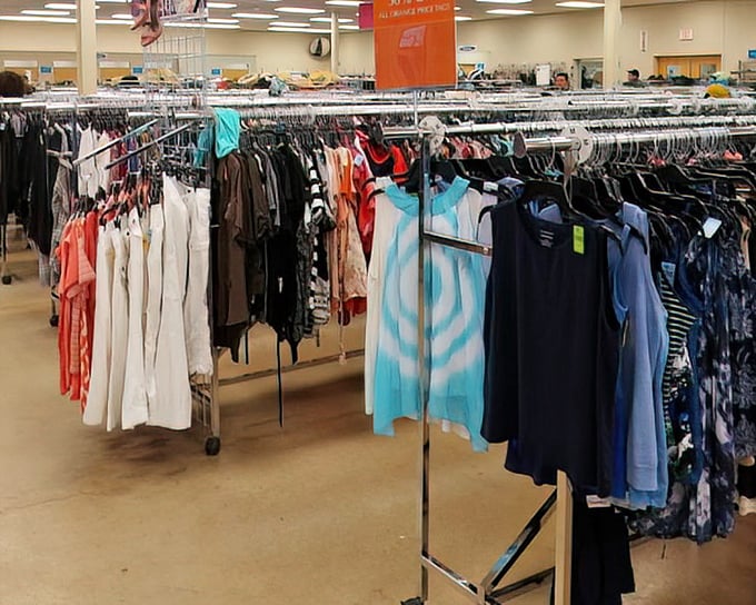Color-coded clothing racks create a rainbow road of possibilities. That turquoise dress might have attended one wedding before waiting here for its second chance.