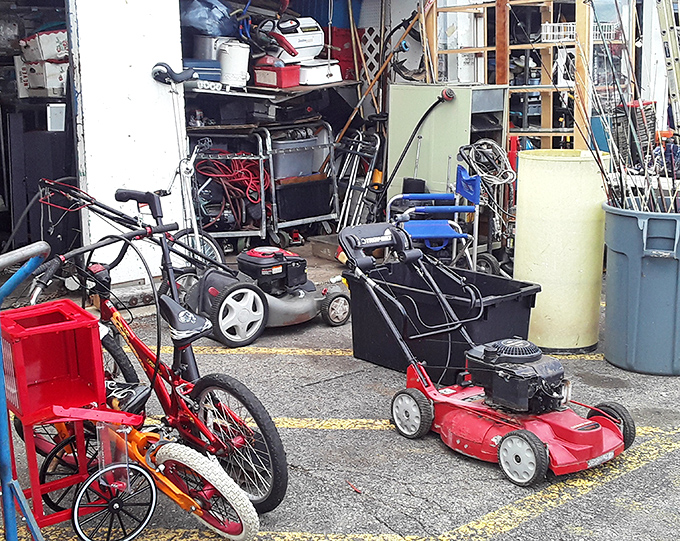 The lawn equipment graveyard, where yesterday's mowers await resurrection by tinkerers who believe everything deserves a second chance.