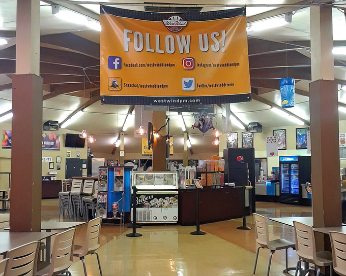 The social hub of the drive-in experience, where strangers become temporary neighbors united by their quest for nachos and Milk Duds.