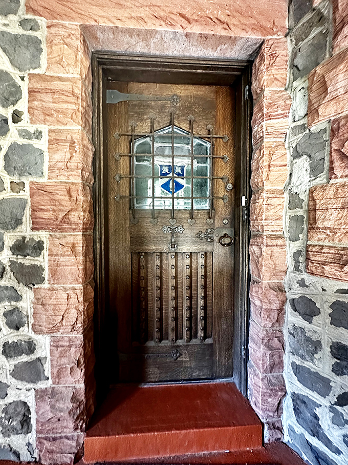 Not your average front door. This wooden entryway with stained glass feels like the perfect portal between our world and a fantasy realm.