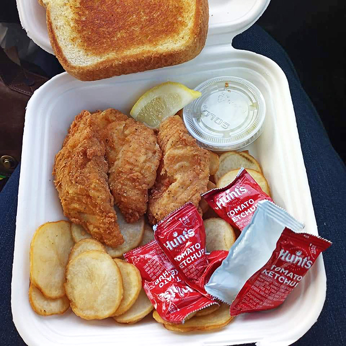 The Chowder Bowl's perfectly crisp fish and chips to-go, featuring golden fillets, potato chips, and tartar sauce&mdash;coastal comfort food at its finest.