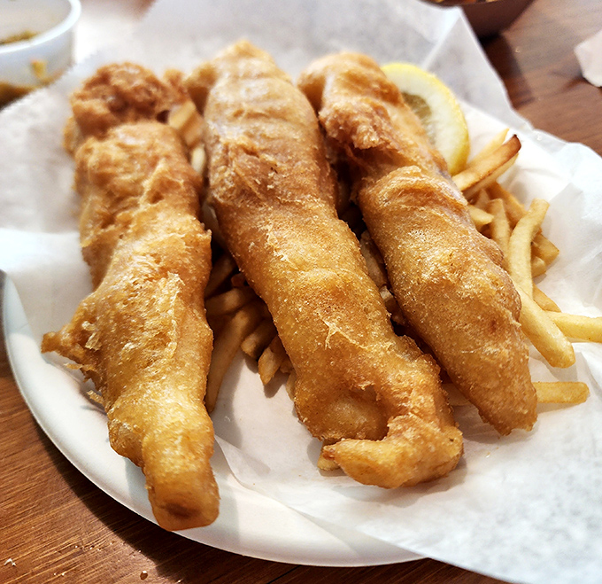 Golden-battered fish that shatters at first bite, paired with fries that could make a Frenchman weep. Simple perfection on paper.
