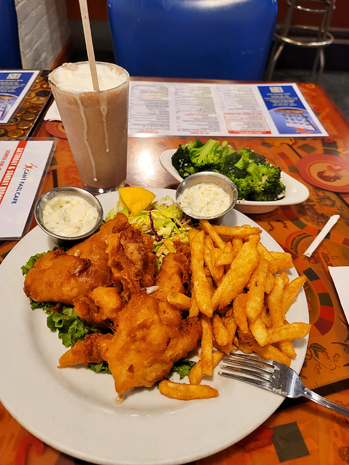 Fish and chips that would make a British pub jealous, with a milkshake thick enough to require Olympic-level straw skills.