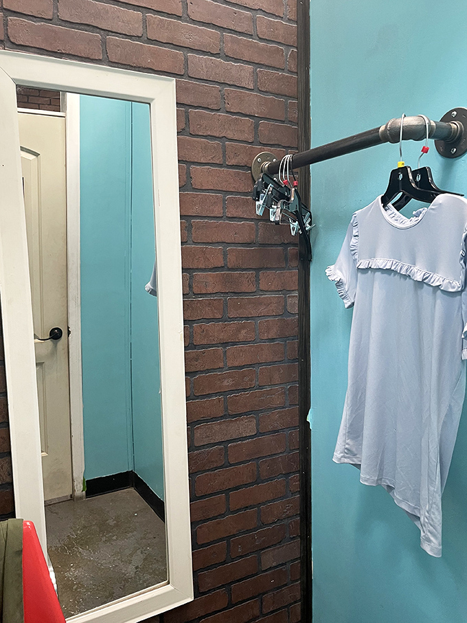 The fitting room awaits with its turquoise walls and no-nonsense mirror. That white dress might be your next summer staple&mdash;only one way to find out!