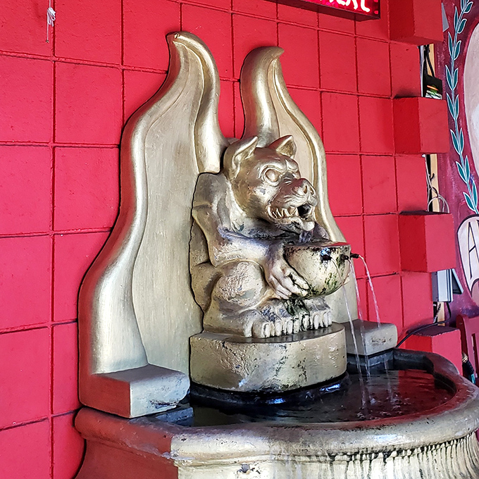 Even the fountain features a demonic cherub, because apparently regular cherubs weren't quite on-brand for this establishment.