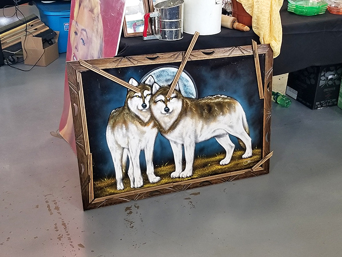 Two wolves stare majestically from their wooden frame, probably wondering how they ended up at a flea market instead of running free in the wild.