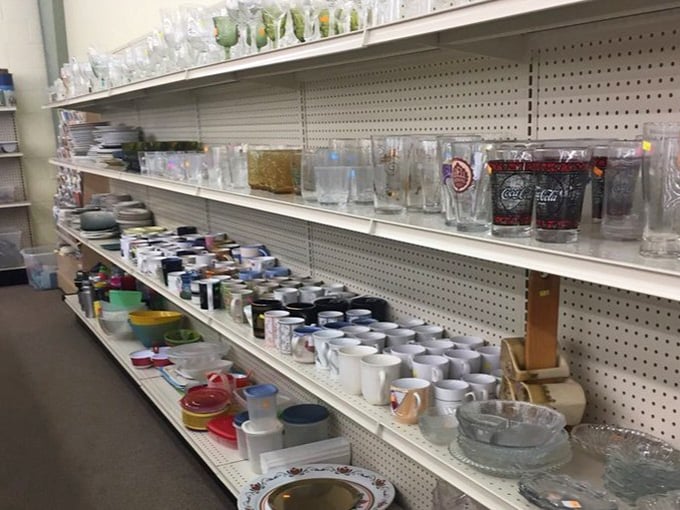 Rows of glassware and mugs stand like soldiers, each one holding memories of someone else's morning coffee or holiday dinners.