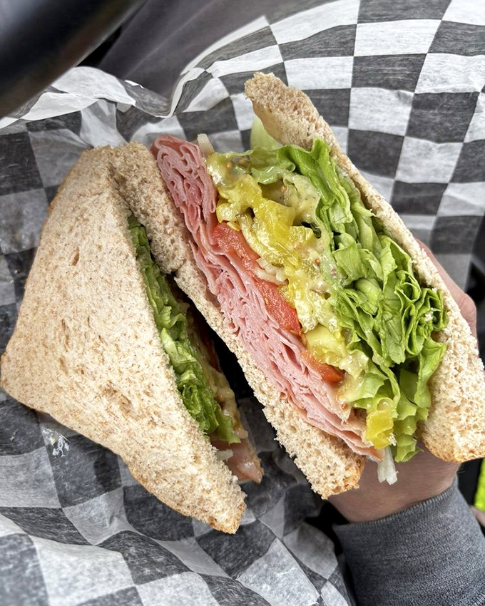 Not just a sandwich but an architectural masterpiece of layered ham, fresh veggies, and what must be the world's most perfectly toasted bread.