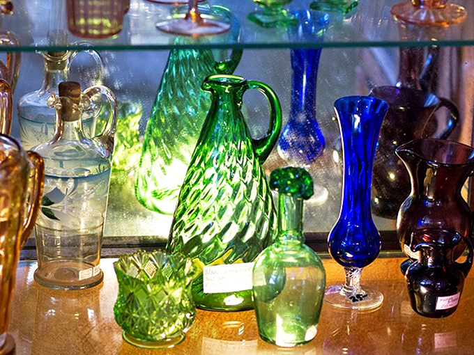 Swirls of emerald and cobalt capture light like liquid jewels. Imagine the Sunday dinners these decanters once presided over.