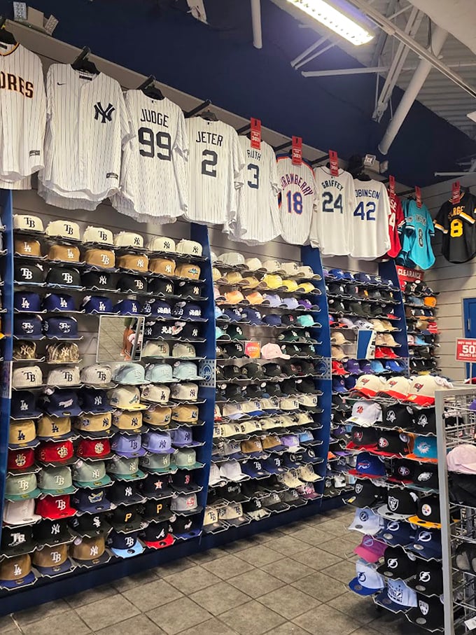 Baseball cap heaven where fans pledge allegiance to their teams while secretly eyeing that rival logo they'd never admit to liking.
