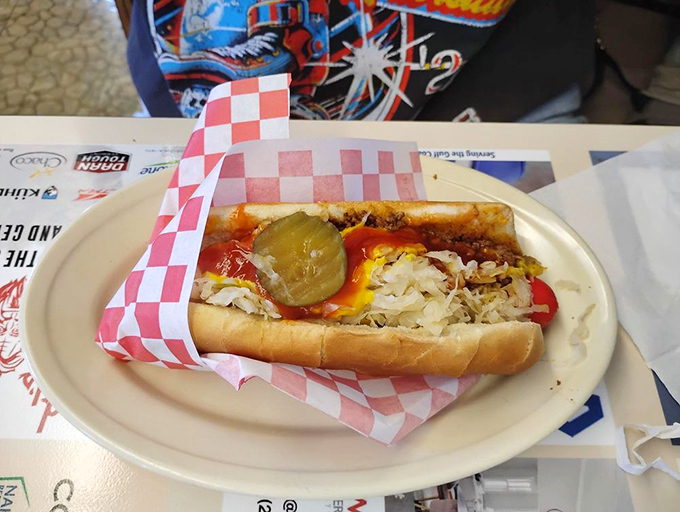 The legendary hot dog arrives dressed to impress with chili, sauerkraut, mustard, ketchup, and a pickle slice riding shotgun.