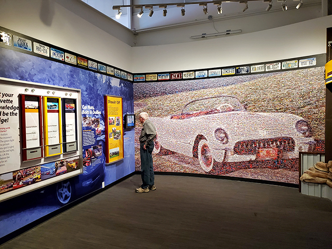 A visitor admires the incredible mosaic wall made from thousands of Corvette photos. One car, countless stories, infinite passion.