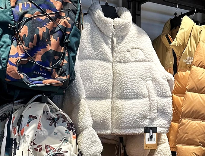 The North Face display featuring the fluffy white jacket that's basically Wisconsin's unofficial winter uniform. Marshmallow chic at its finest.