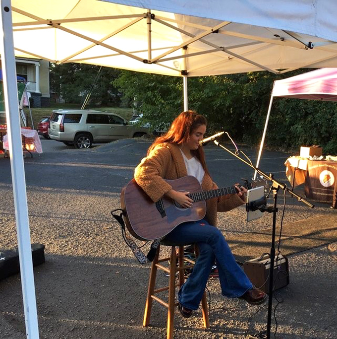 The market's soundtrack isn't piped-in muzak, but the authentic strum of local musicians adding the perfect garnish to your shopping experience.