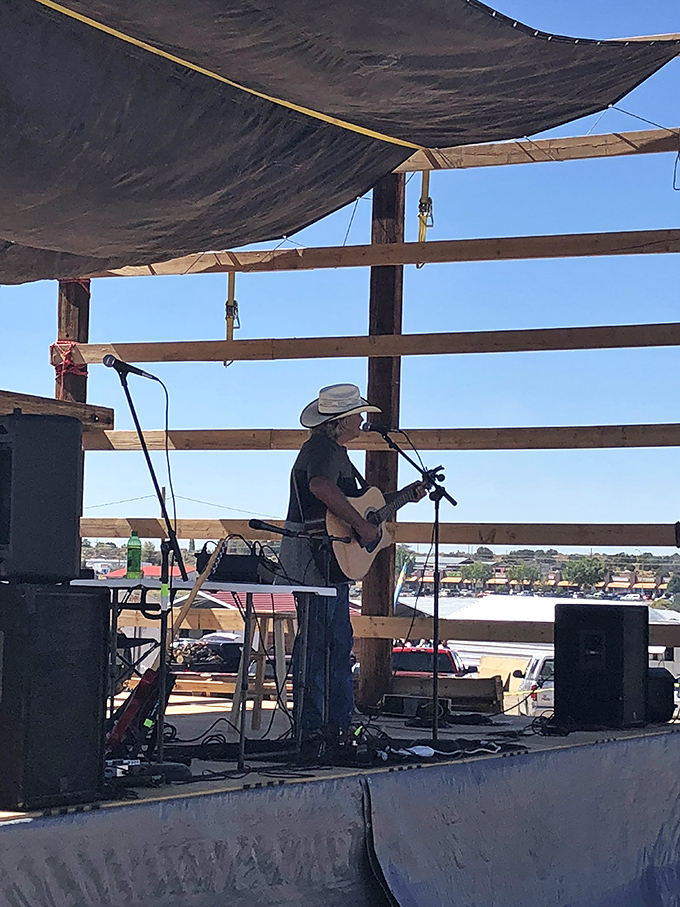Live music transforms shopping into an experience. This cowboy troubadour provides the soundtrack for your treasure hunting adventure.