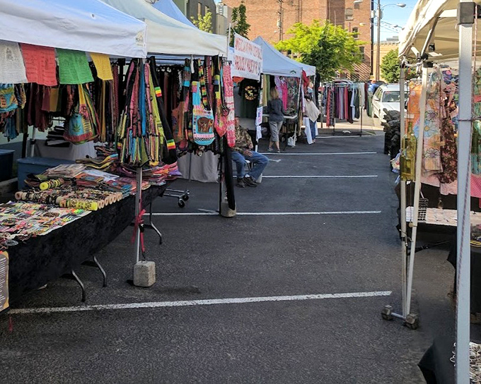 Vibrant textiles flutter like flags in the gentle Montana breeze, a kaleidoscope of colors against the urban backdrop.