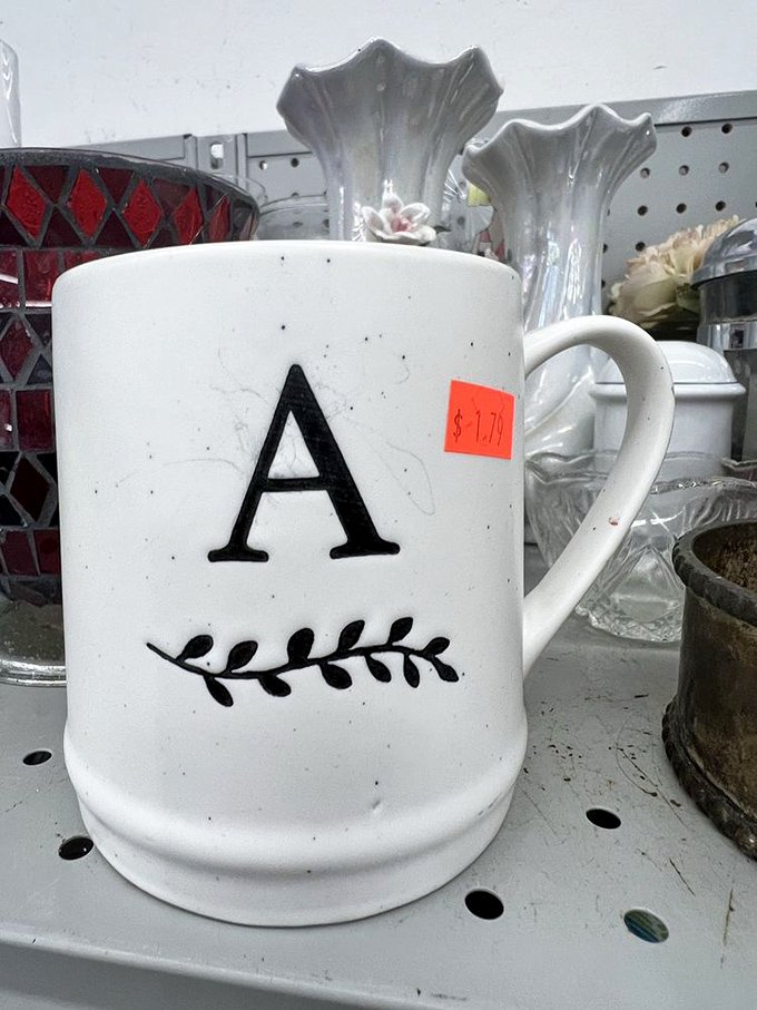 A monogrammed mug that's seen better days but still has stories to tell&mdash;perfect for that morning coffee that tastes better with a side of thrift store victory.