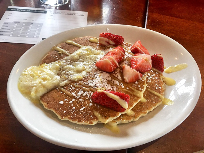 Golden pancakes adorned with fresh strawberries&mdash;proof that sometimes the simplest pleasures are worth getting out of bed for.