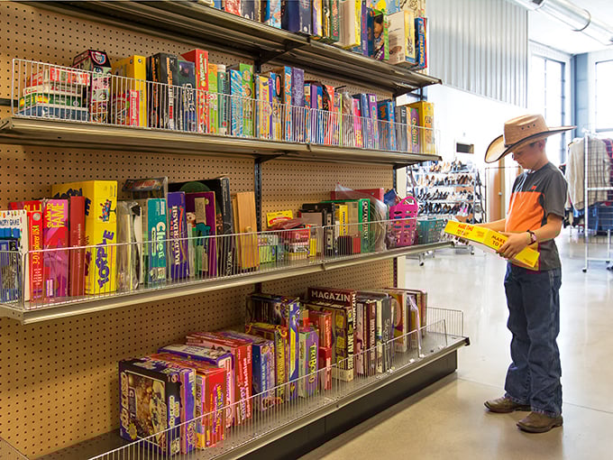 A young shopper contemplates board games that once gathered families around kitchen tables&mdash;proof that entertainment doesn't need batteries or Wi-Fi.