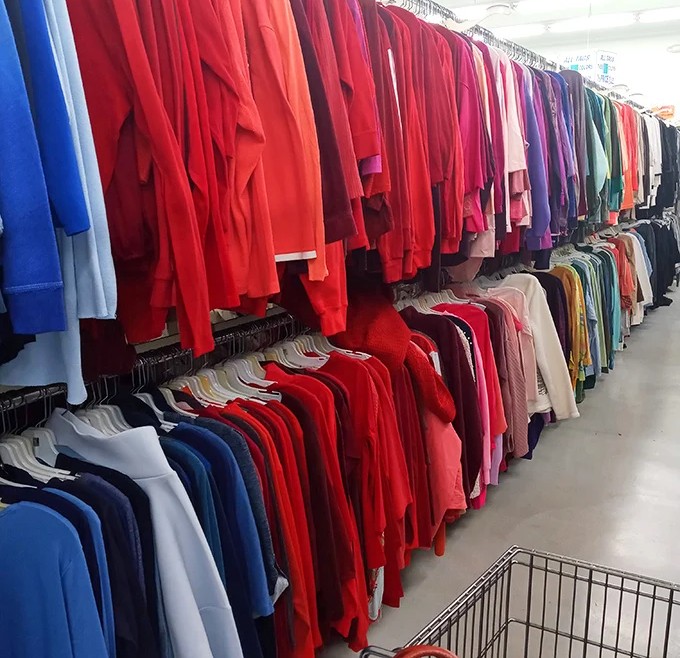A rainbow of jackets organized by color&mdash;thrift store feng shui at its finest. Red section looking particularly robust today!