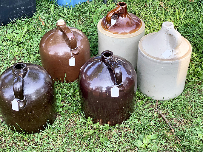 These stoneware jugs once held everything from whiskey to maple syrup. Now they stand like sentinels of a time when "storage container" meant something built to outlast its owner.