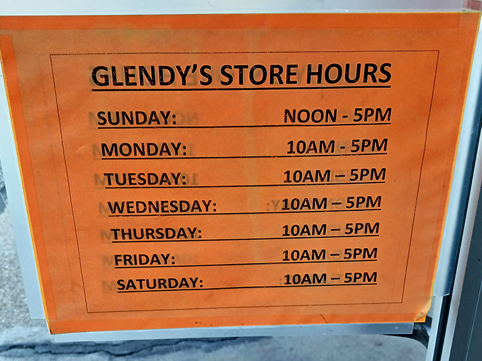 The store hours sign&mdash;your portal to time travel is open daily. Sunday's noon opening gives you time for brunch before your antiquing adventure.