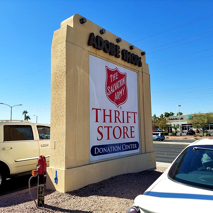 The Adobe Shops sign stands sentinel at the entrance, a desert landmark guiding bargain hunters to their promised land.
