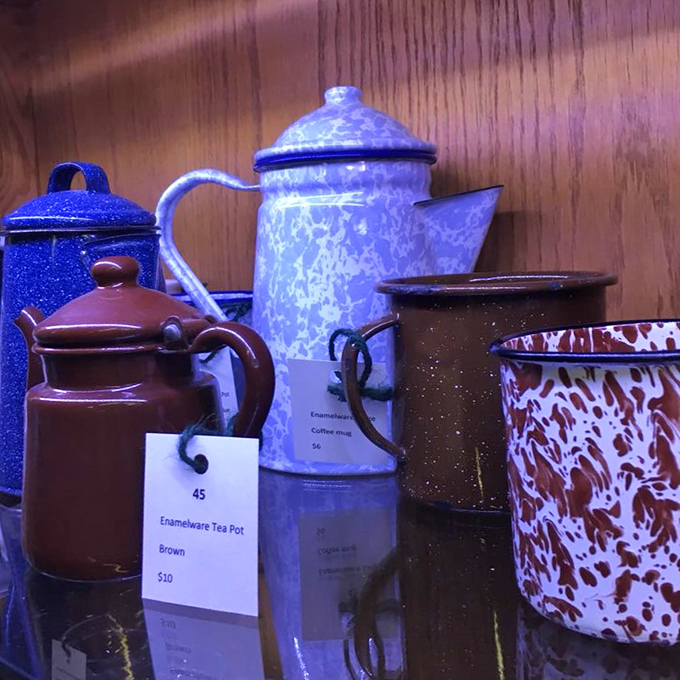 Enamelware that survived decades of use now waits for new kitchens to brighten. That blue speckled coffee pot has poured thousands of morning cups.