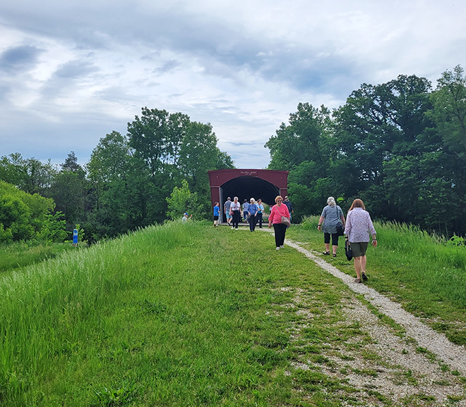 Fellow explorers make the pilgrimage down the grassy path, drawn by the same timeless appeal that's captivated visitors for generations.