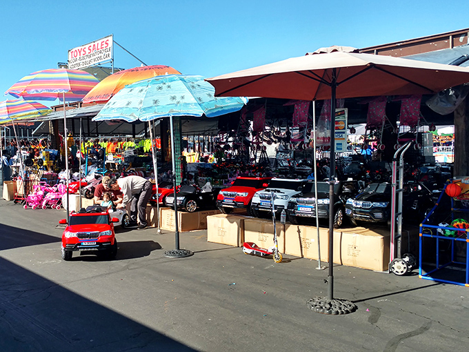 From ride-on cars to colorful umbrellas, this toy vendor's setup looks like a childhood dream crossed with a parking lot.