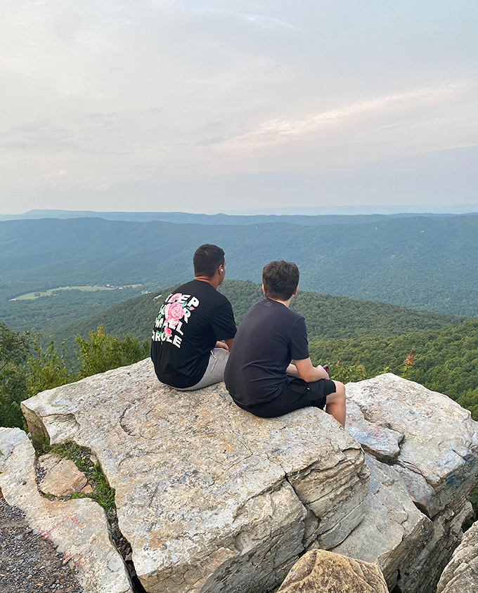 Two visitors discovering that sometimes the best conversations happen when you're both staring at the same incredible view.