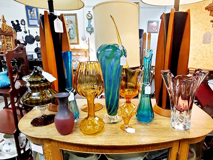 Glass treasures catching the light like liquid jewels—each vase with its own personality, from sophisticated amber to that showstopping turquoise that demands center stage.