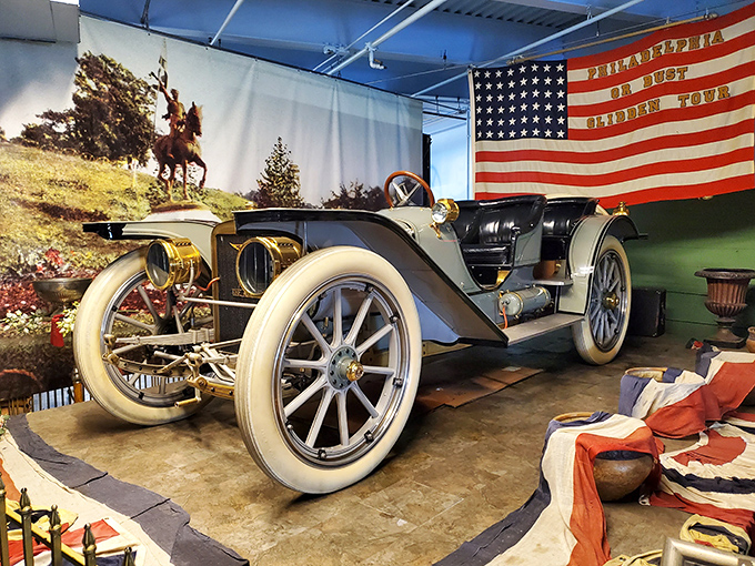 This elegant vintage roadster sits beneath an American flag, reminding us that automotive passion is as American as apple pie and arguing about sports.