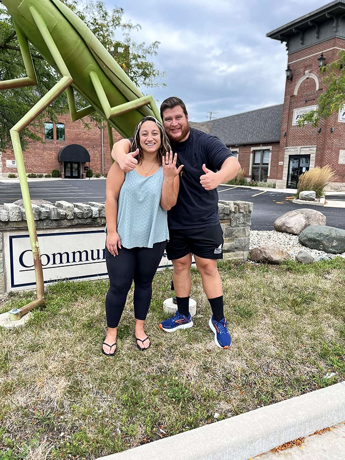 The couple's engagement photo takes on a distinctly Indiana flavor with KokoMantis serving as their oversized lime-green witness.
