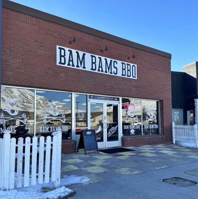 Bam Bams' straightforward brick building with white picket fence. No frills needed when your BBQ speaks volumes through smoke signals.