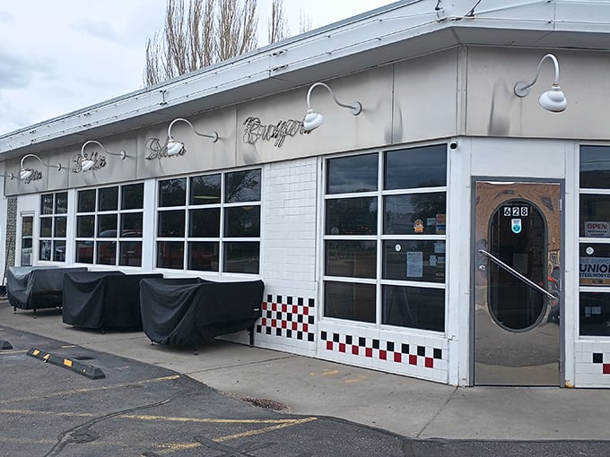 Broadway Burger Station's classic white exterior with those distinctive gooseneck lights whispers of simpler times and better burgers.