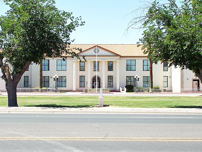 Coolidge's Municipal Complex stands proudly under that endless Arizona sky. Those palm trees aren't just decorative &ndash; they're exclamation points!