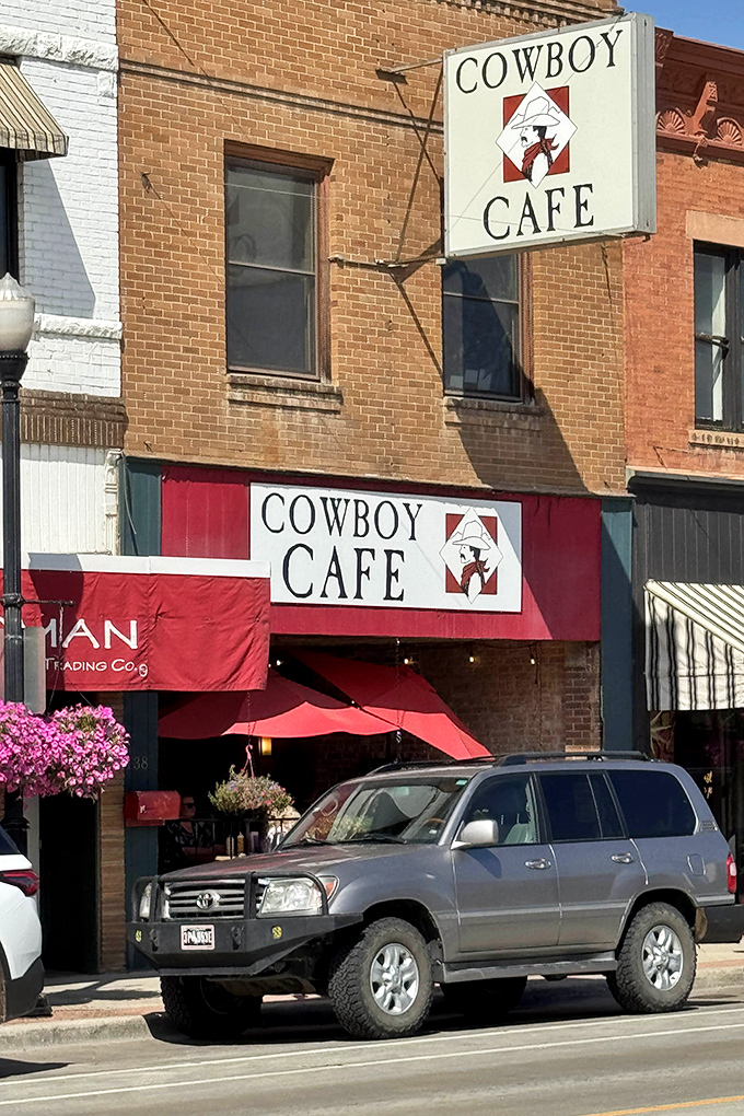 The Cowboy Cafe's bold red awning stands out like a beacon of breakfast hope on Sheridan's Main Street.