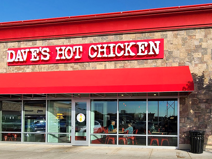 Dave's Hot Chicken's modern stone facade and bright red awning &ndash; warning signs that heat lies ahead!