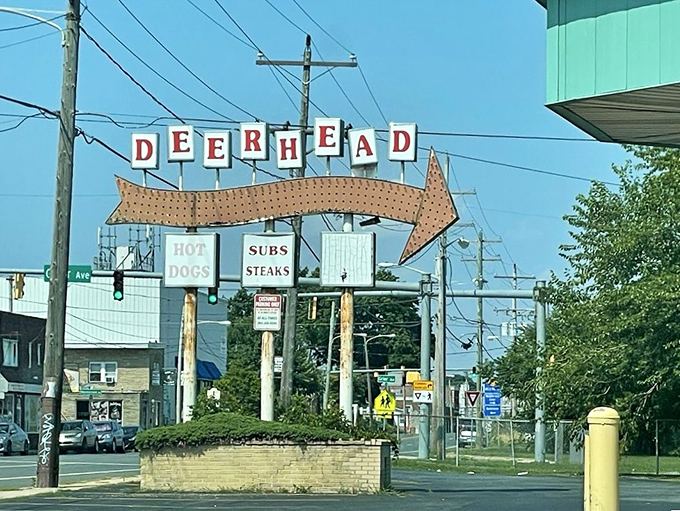 That classic arrow sign stretching across the street announces hot dog heaven louder than any billboard could.