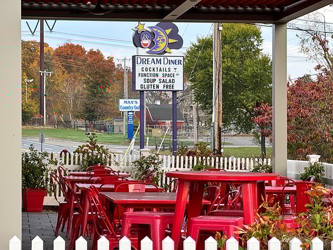 Dream Diner's cheerful outdoor seating area with bright red tables invites you to linger over coffee and conversation on sunny Massachusetts mornings.