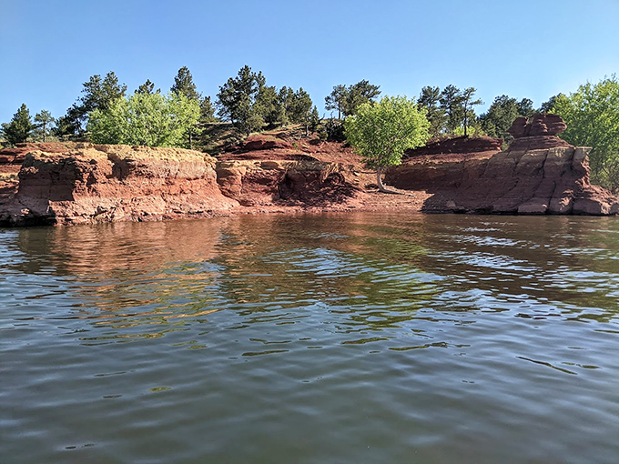 Red rock formations rise from the water like ancient sculptures carved by the world's most patient artist.